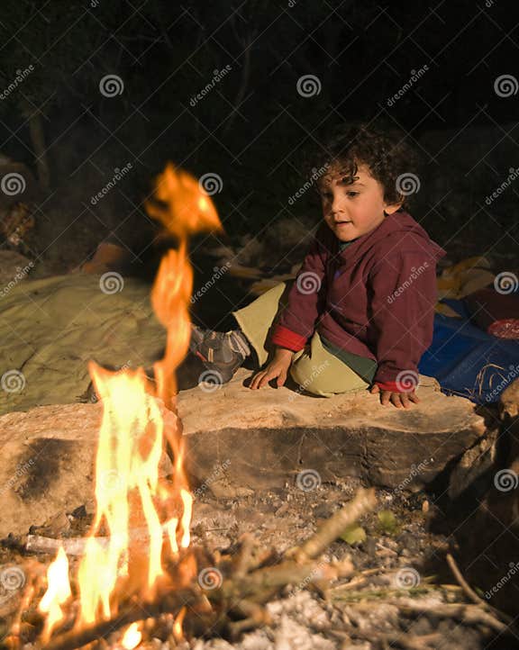 Boy at campfire stock image. Image of heat, firewood, flame - 5131543