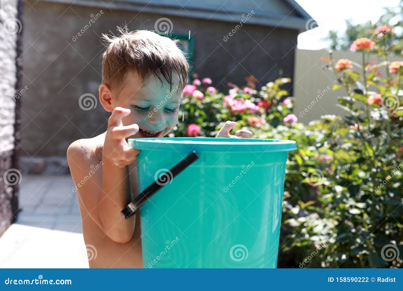 Boy Catches Drops of Water with Bucket Stock Photo - Image of childhood ...