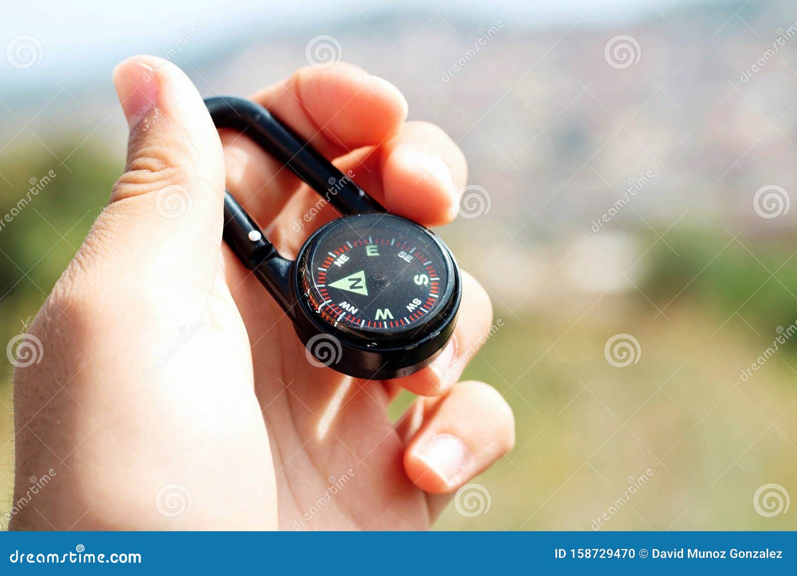 Boy Catching a Black Modern Compass Showing the Direction in the Forest ...