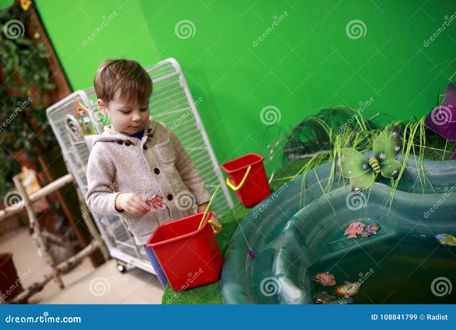 Boy catching toy fish stock image. Image of lonely, creativity - 108841799