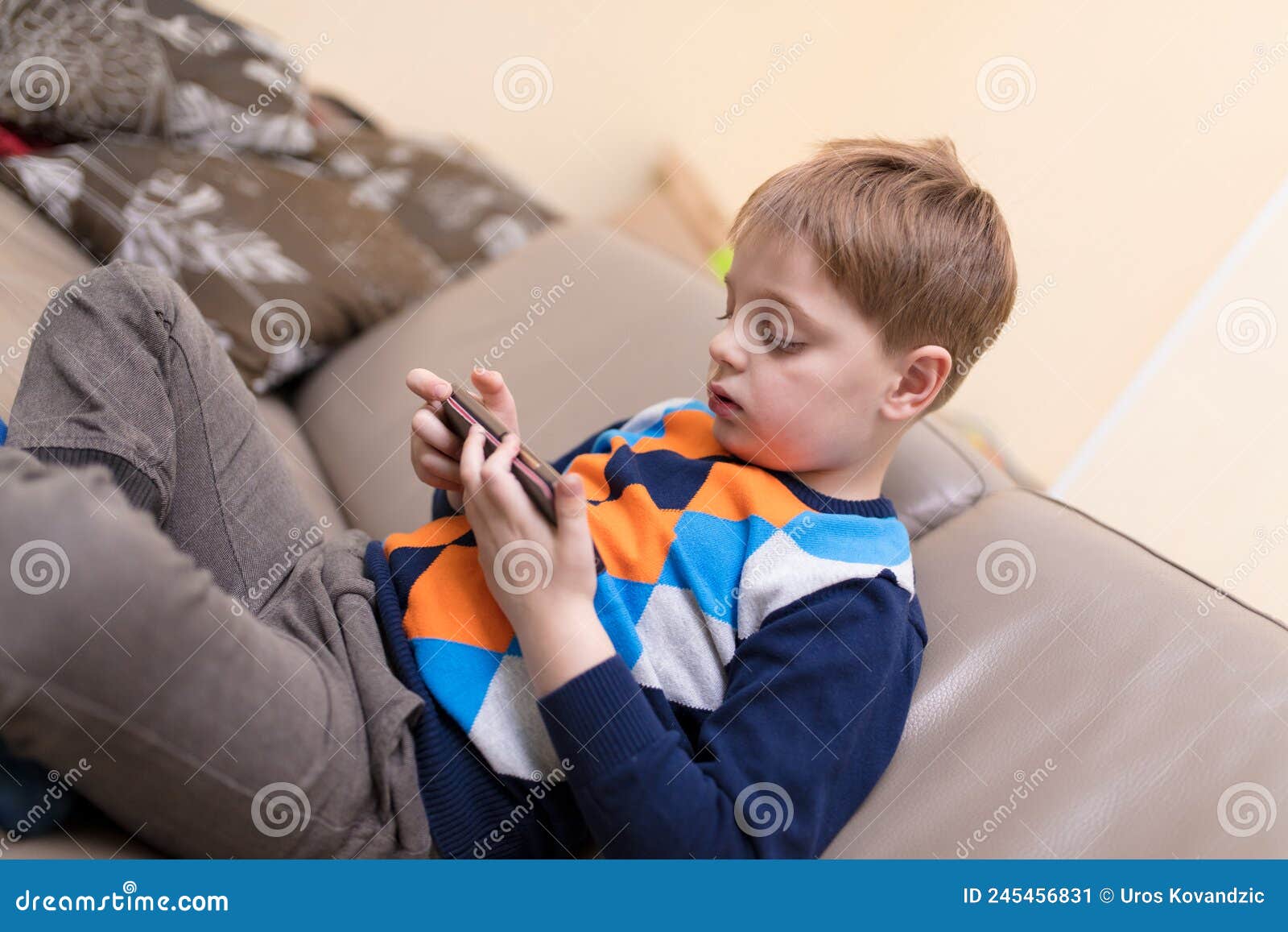 Boy with cellphone stock image. Image of telephone, home - 245456831