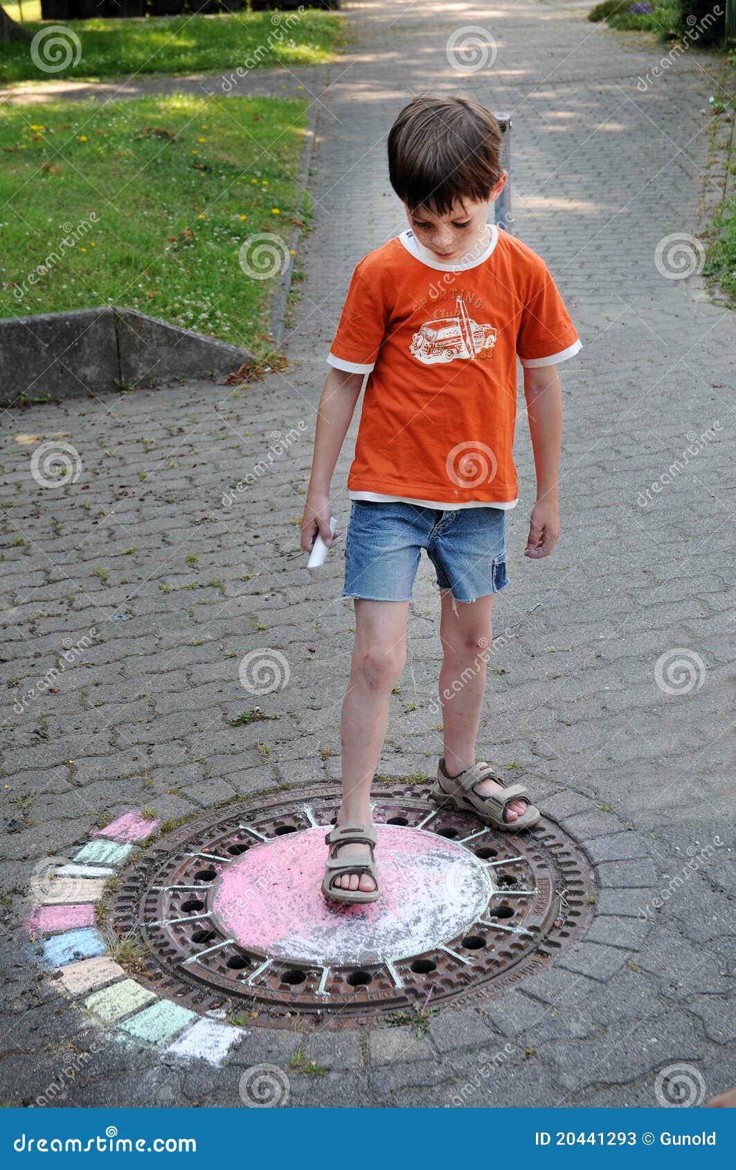 Boy chalking the street stock image. Image of playful - 20441293