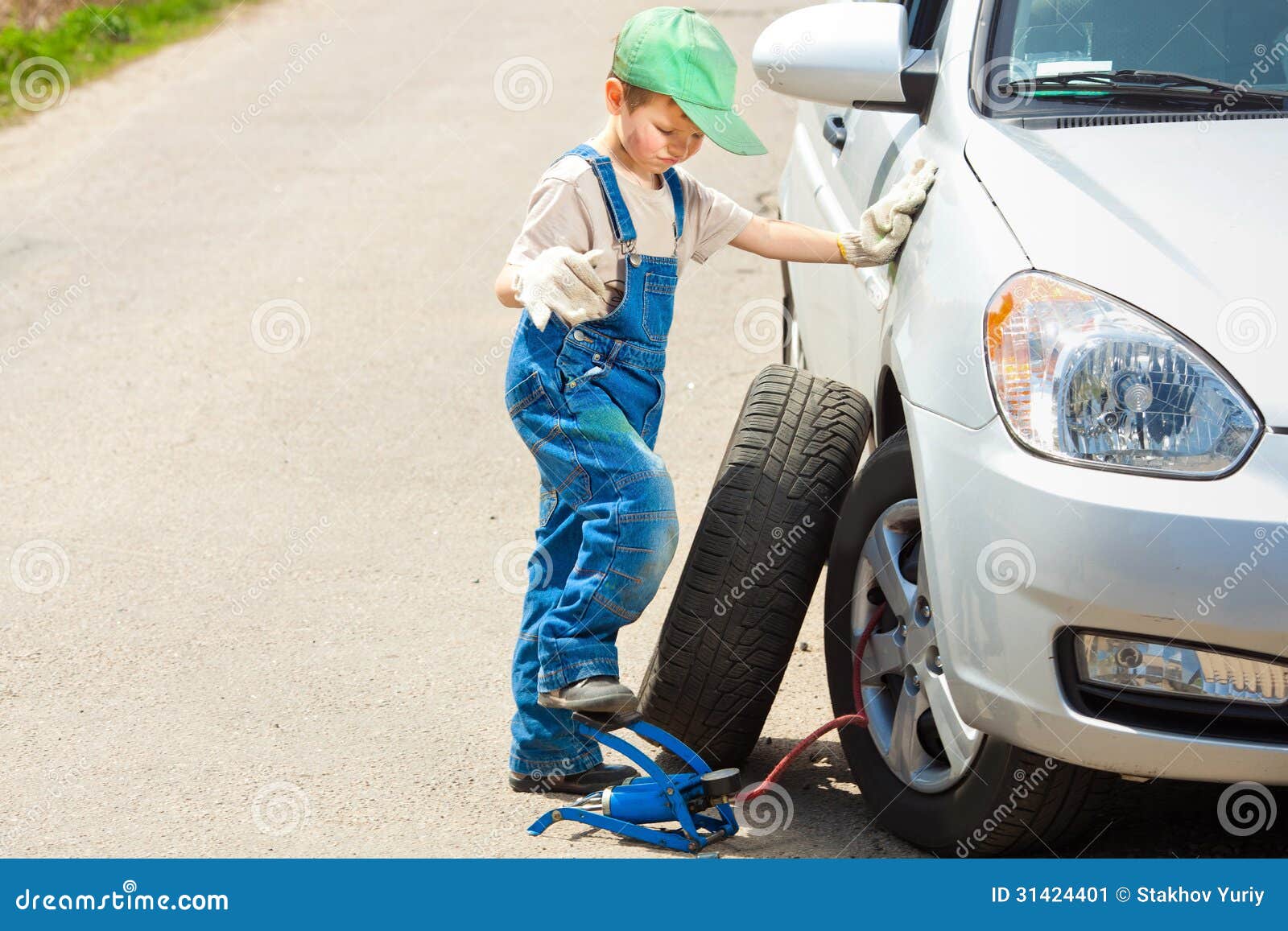 Boy changes the wheel stock image. Image of overalls - 31424401