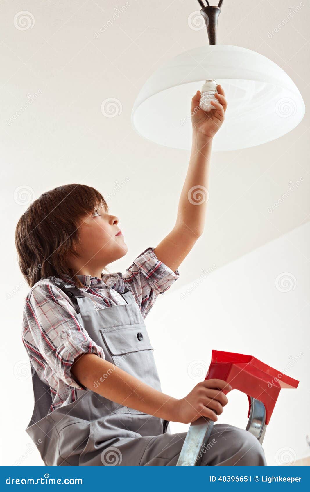 Boy changing lightbulb stock image. Image of young, electricity - 40396651