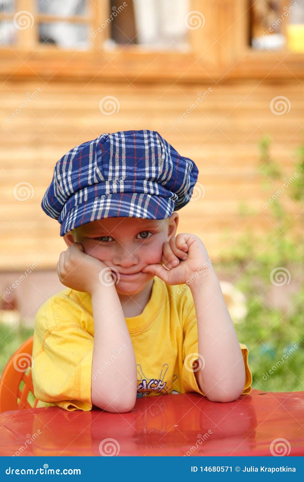 Boy in checkered blue cap stock image. Image of gaze - 14680571