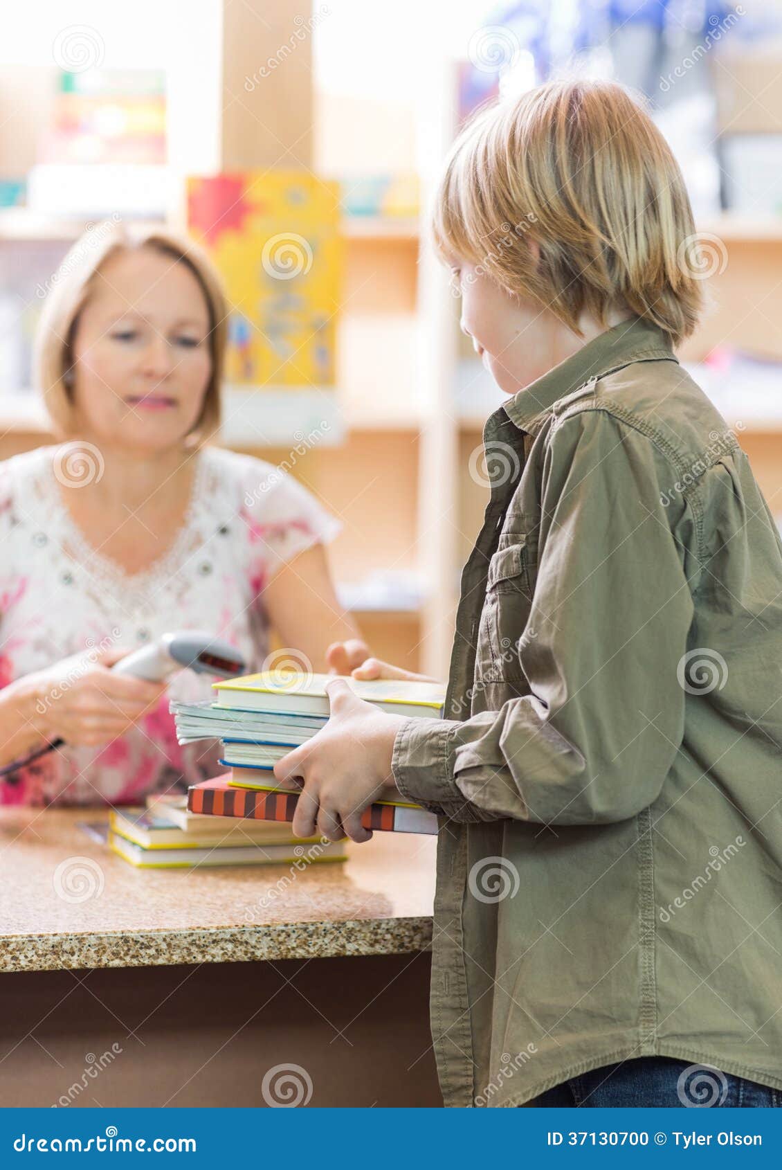Boy Checking Out Books from Library Stock Photo - Image of leisure ...