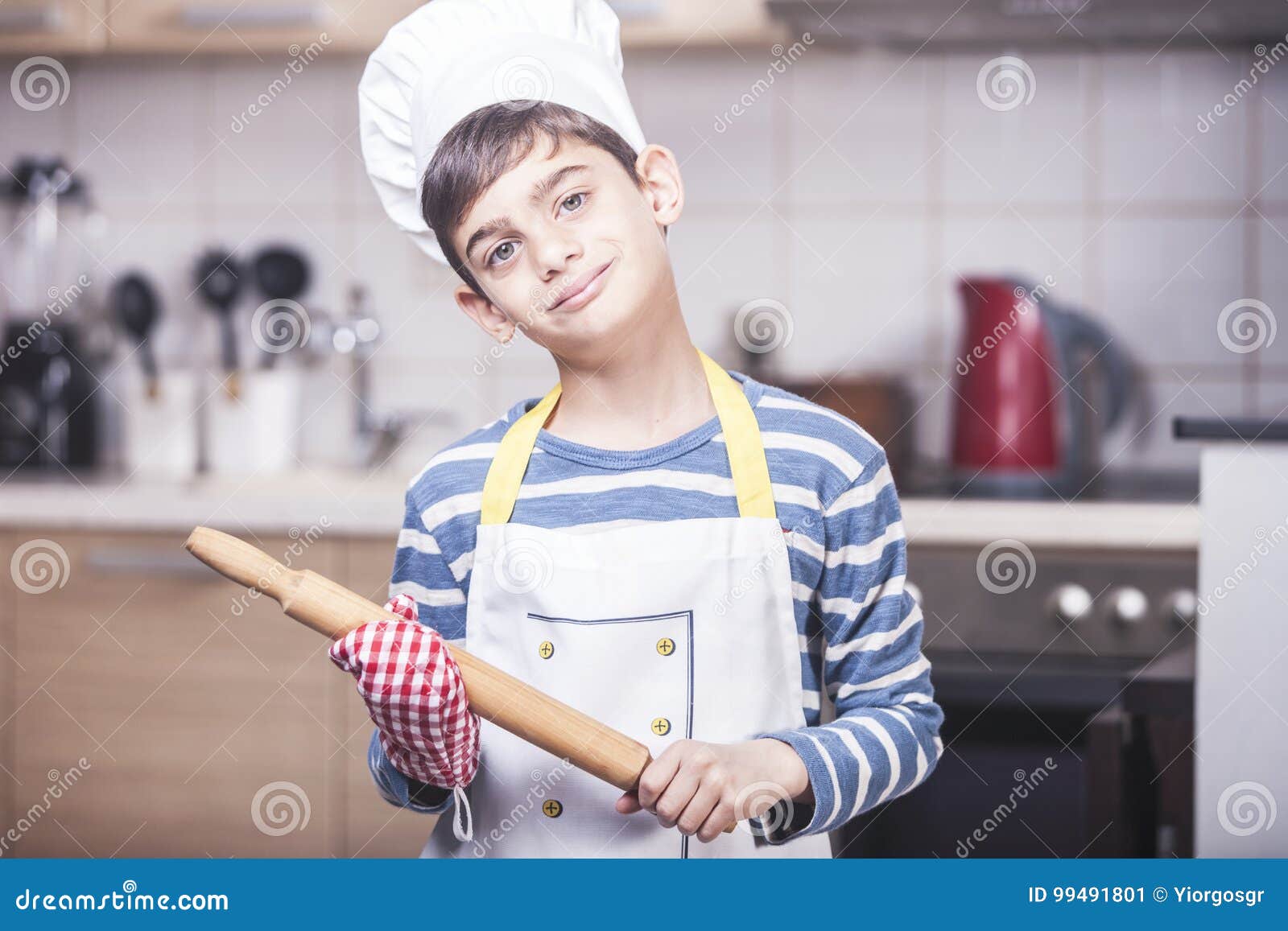 Boy chef in the kitchen stock image. Image of baking - 99491801