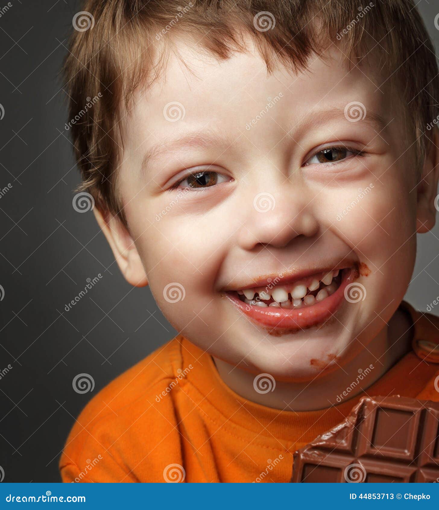 Boy with chocolate bar stock image. Image of indoors - 44853713