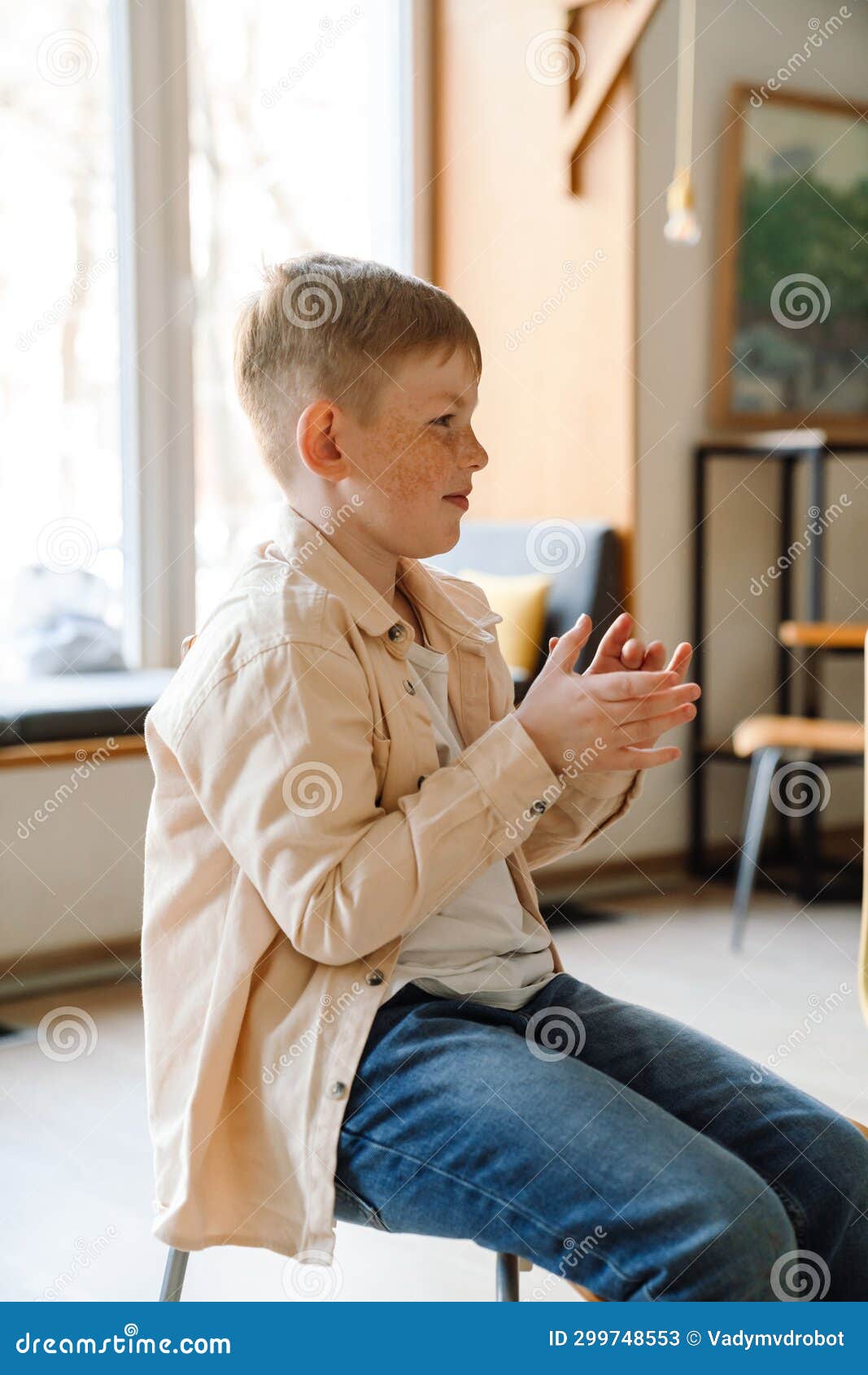 Boy Clapping Hands while Sitting in Classroom Stock Image - Image of ...
