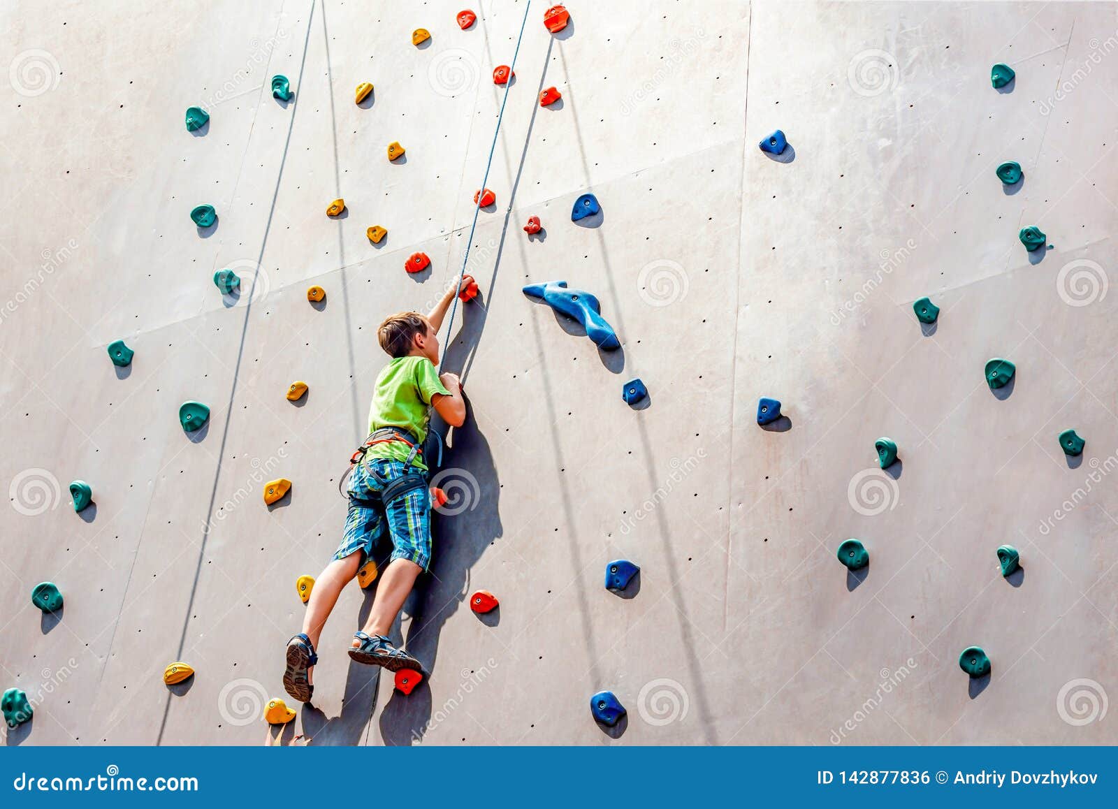 Overcoming Obstacles. Little Girl Climbing On A Rope In Adventure Park ...