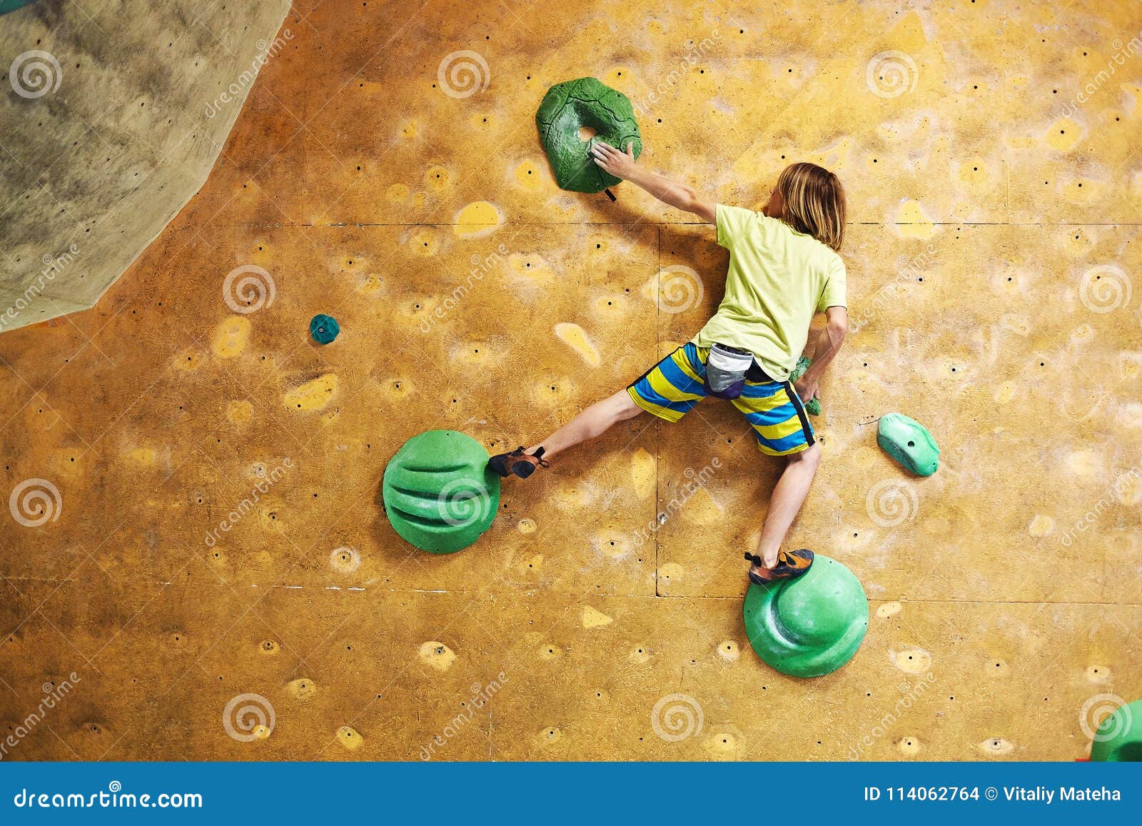 Boy climber climbs indoors stock photo. Image of effort - 114062764