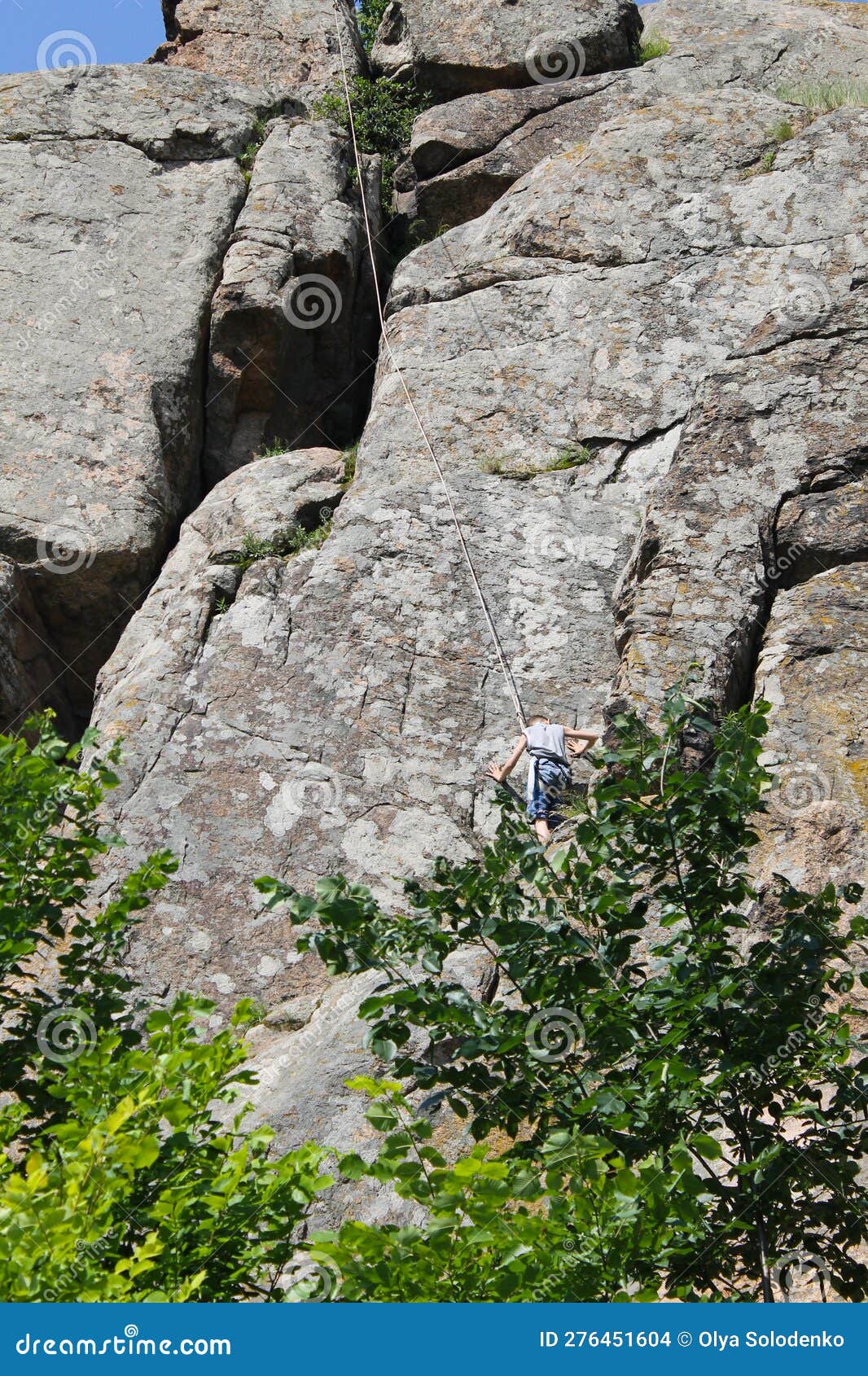 Boy climbing on rock stock photo. Image of healthy, outdoor - 276451604