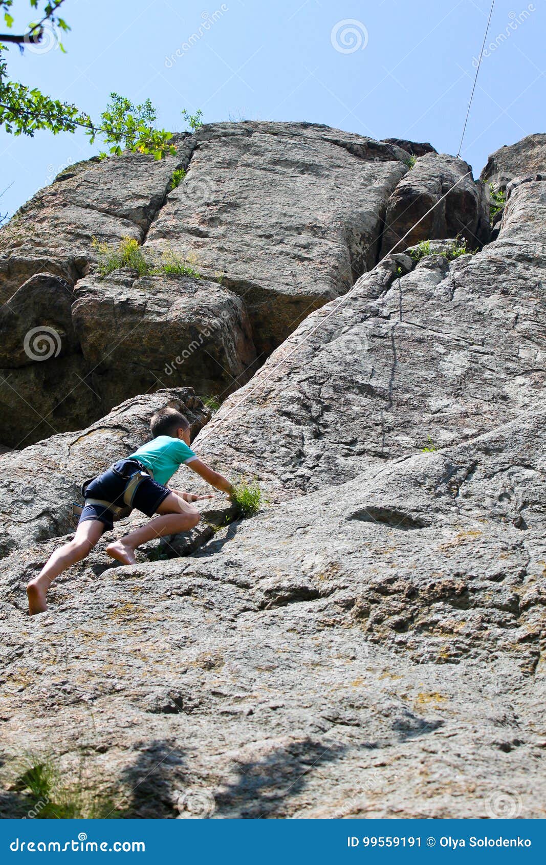 Boy climbing on a rock editorial photo. Image of healthy - 99559191
