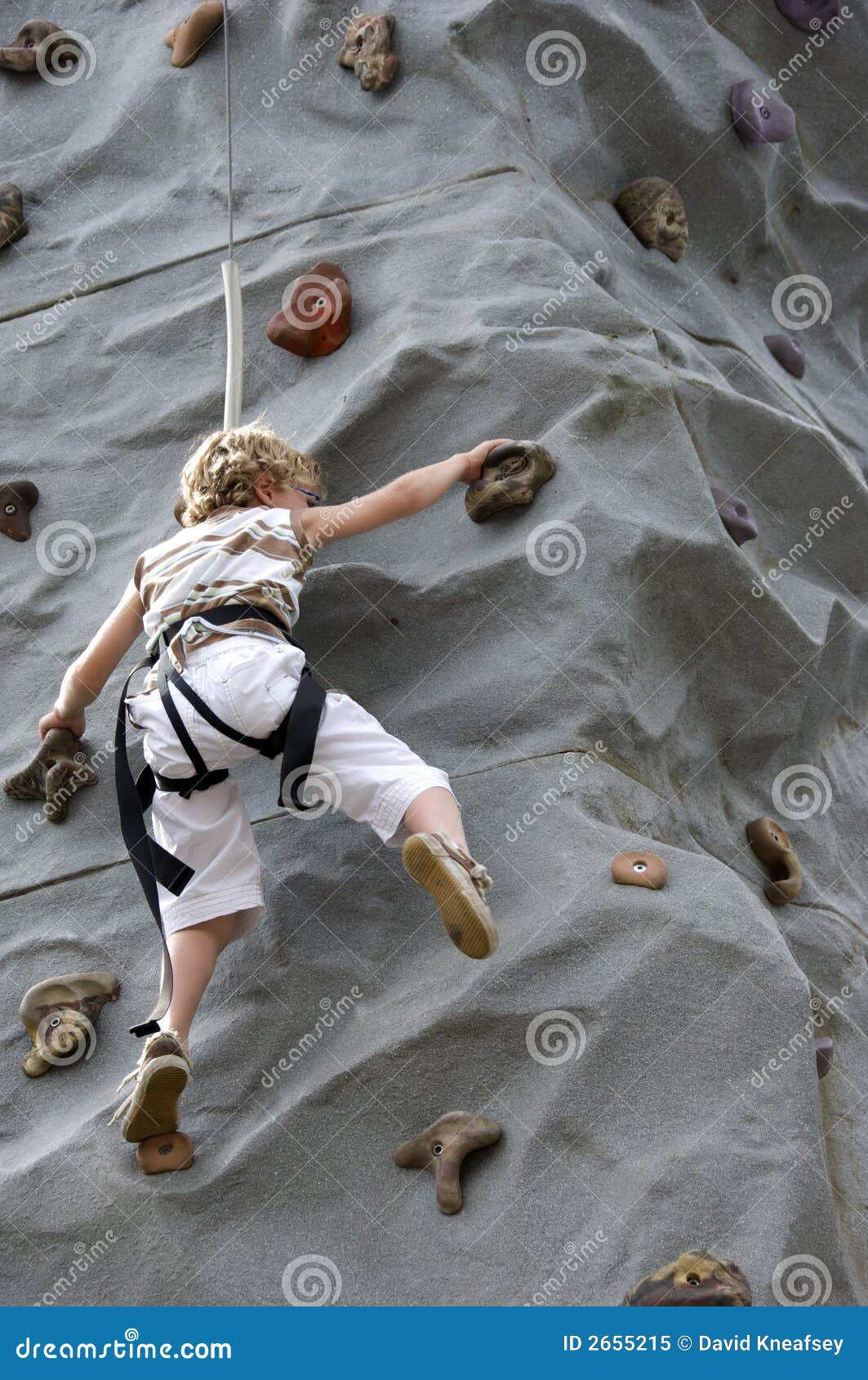 Boy climbing rock wall stock image. Image of mountain - 2655215