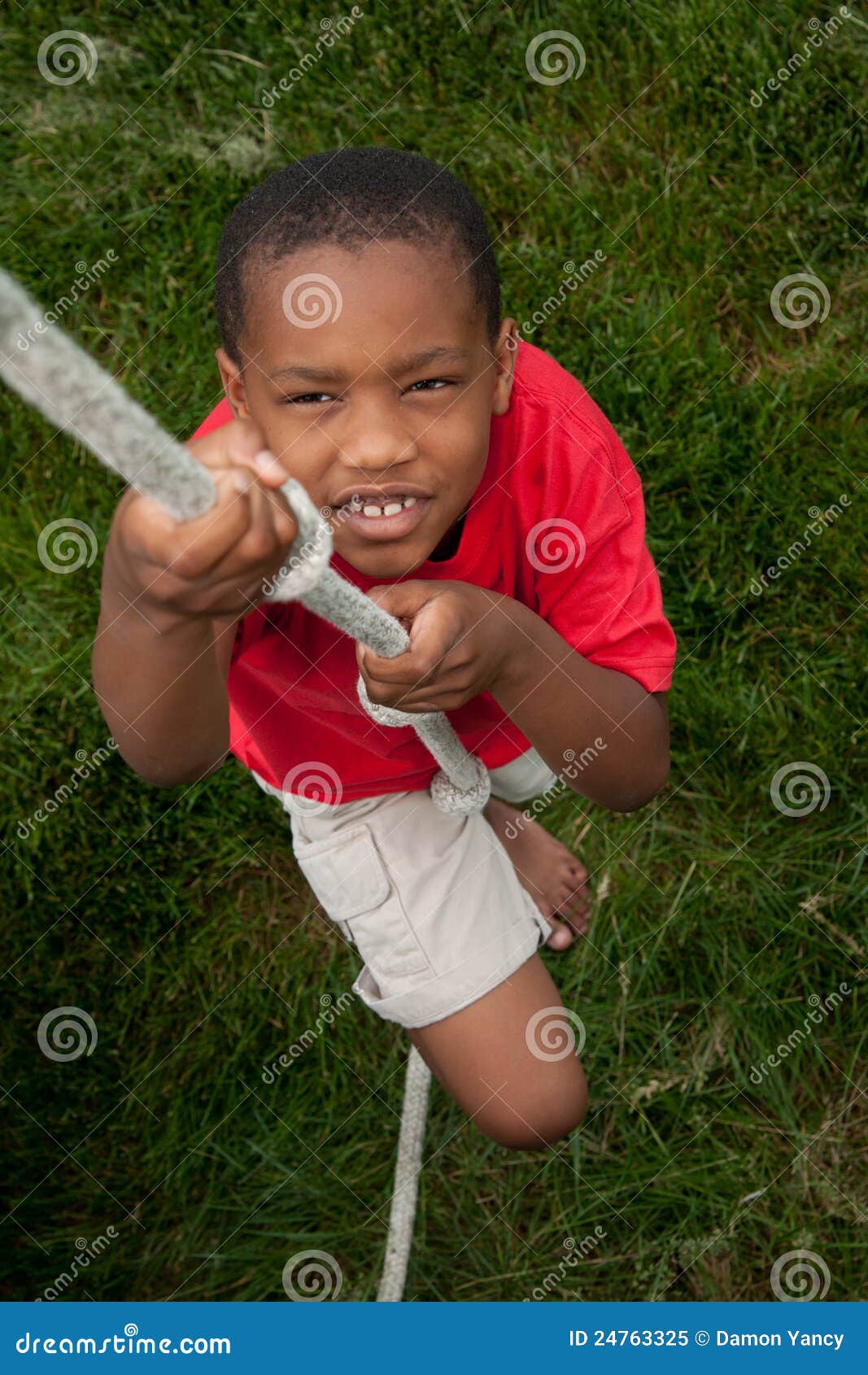 Boy climbing a rope stock image. Image of rope, black - 24763325