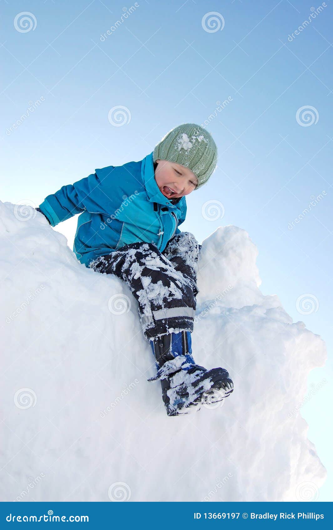 Boy climbing on snow pile stock image. Image of pile - 13669197