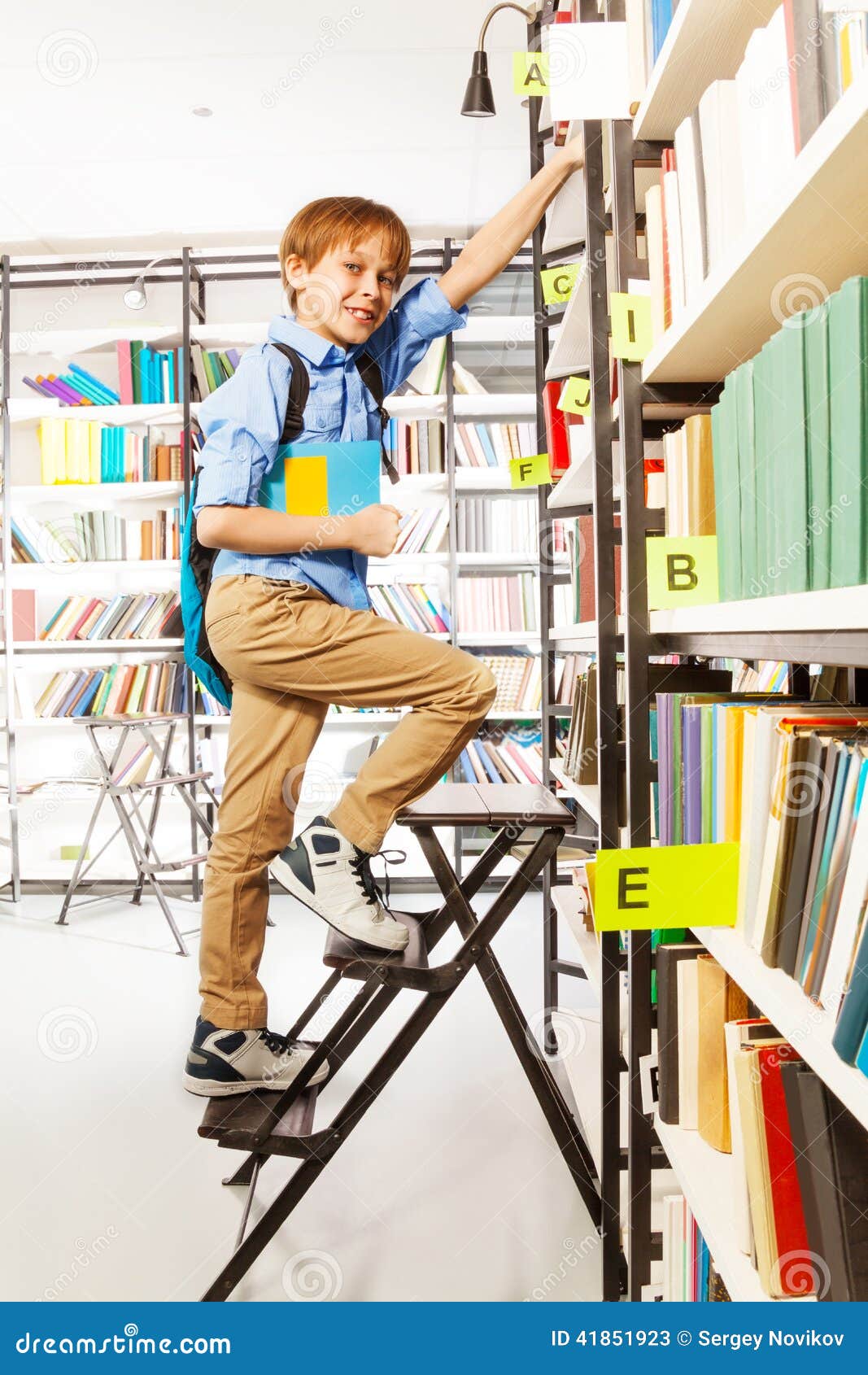 Boy Climbing on Step Ladder in Library Stock Image - Image of knowledge ...
