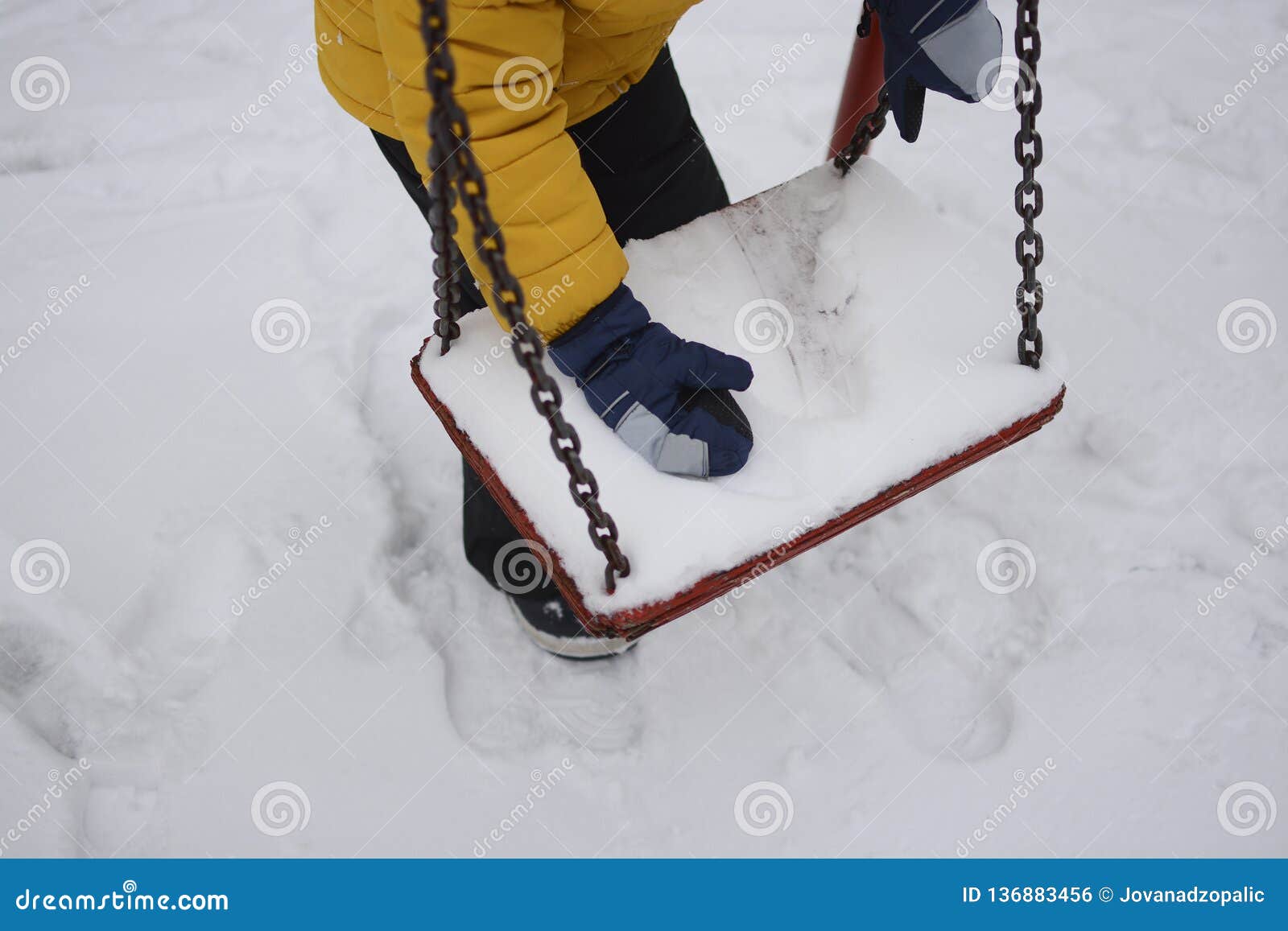 A Boy Collects Snow with a Swing in the Park Stock Photo - Image of ...