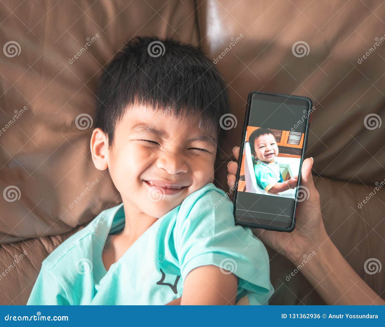 Boy Comparing Himself with His Baby Picture Stock Photo - Image of ...