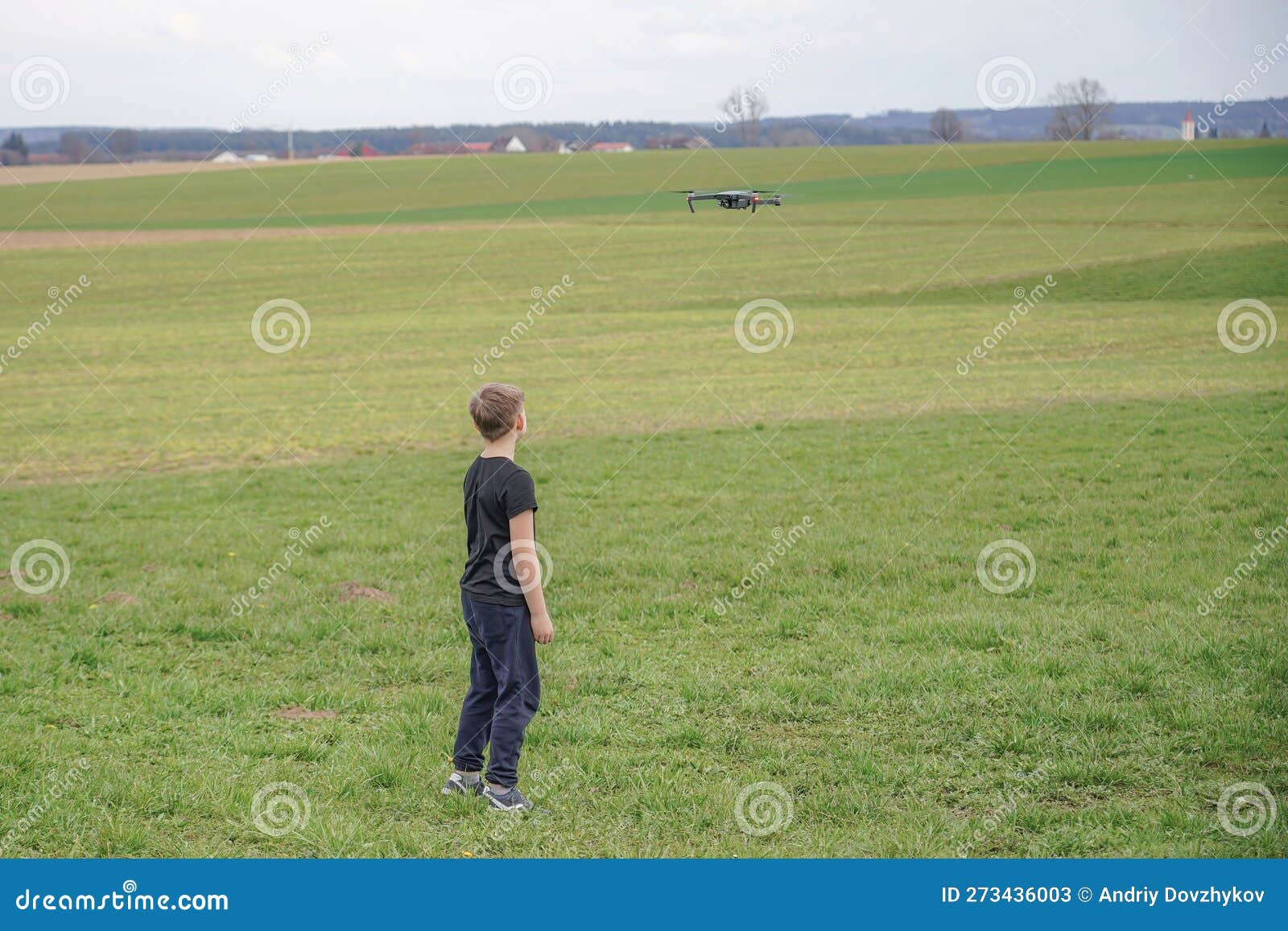 The Boy Controls the Flight of the Quadcopter Using the Remote Control ...