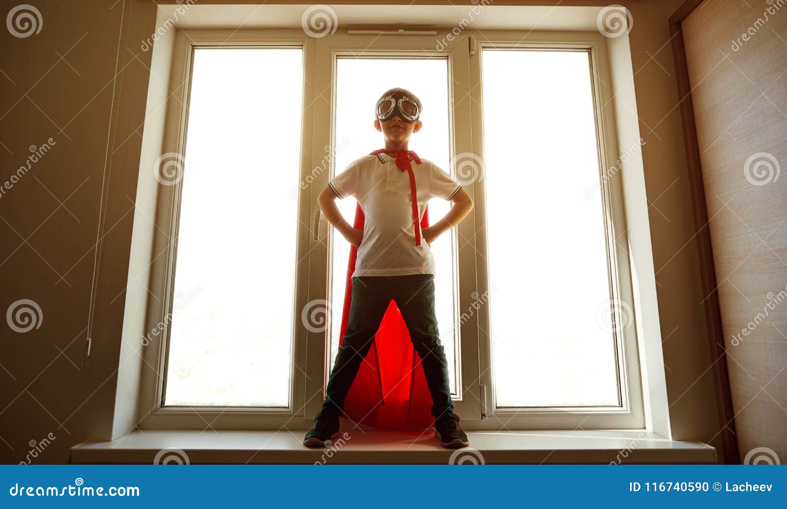 The Boy in the Costume of a Superhero at the Window Stock Photo - Image ...