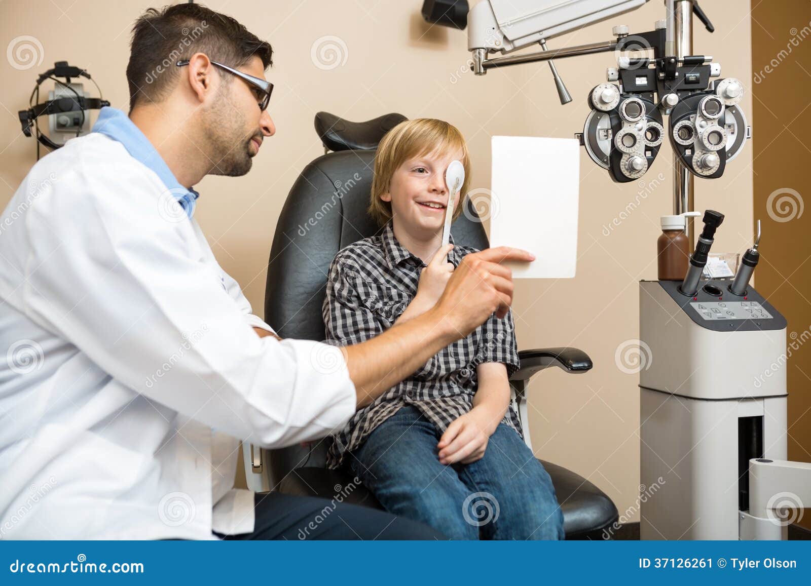 Boy Covering Eye with Occluder at Optometrist Stock Image - Image of ...