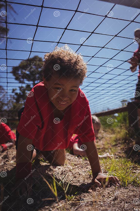 Boy Crawling Under the Net during Obstacle Course Training Stock Image ...