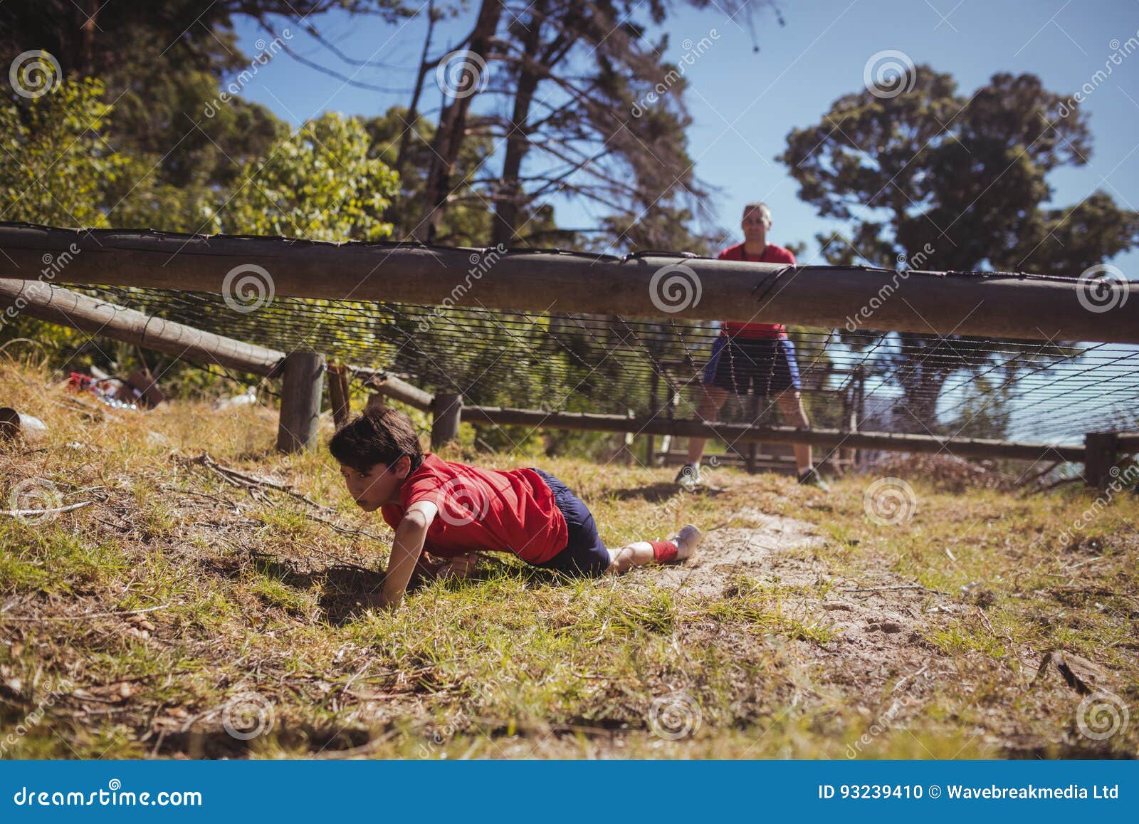 Boy Crawling Under the Net during Obstacle Course Training Stock Photo ...