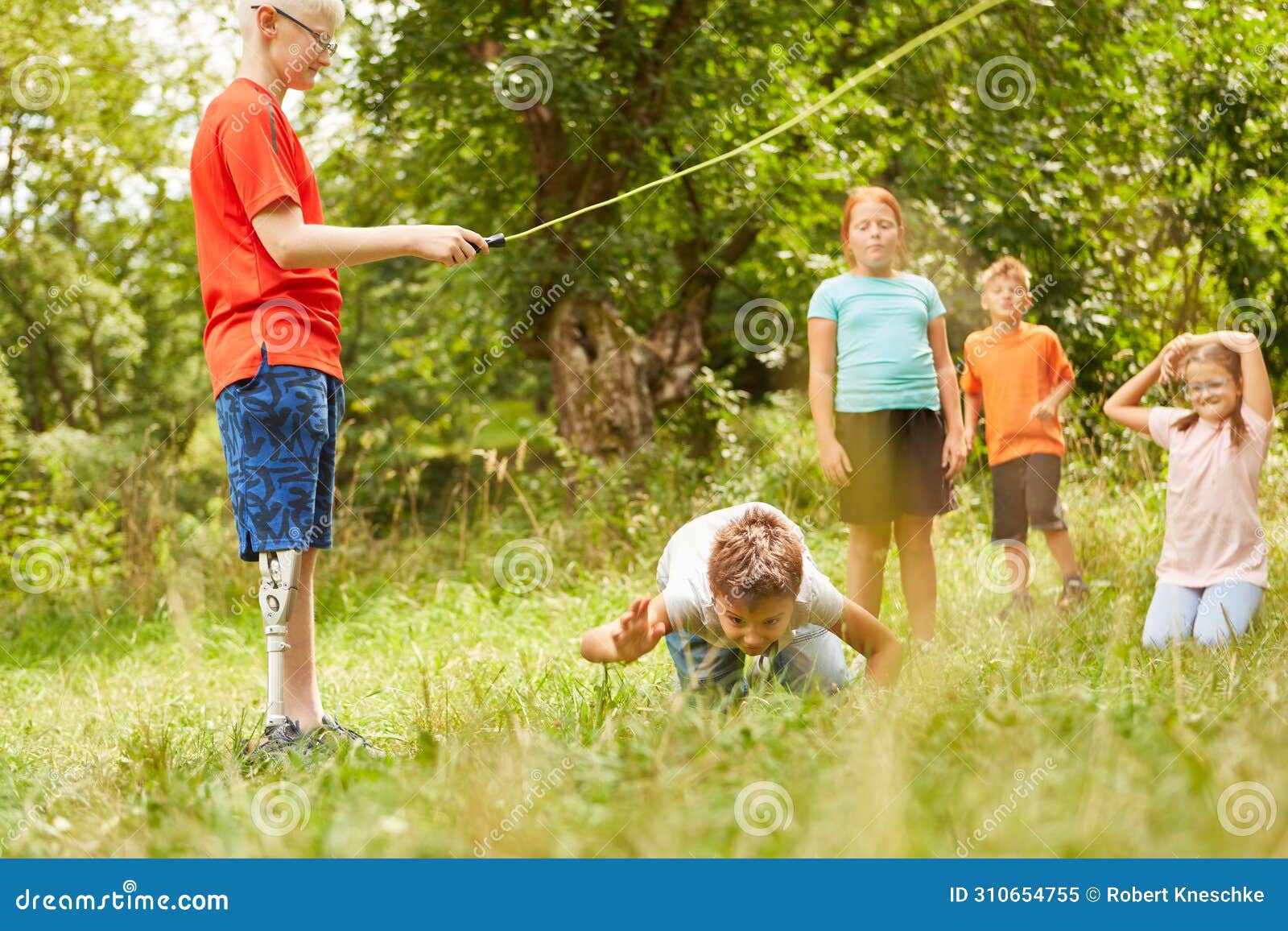 Boy Crawling Under Skipping Rope on Grass at Park Stock Image - Image ...