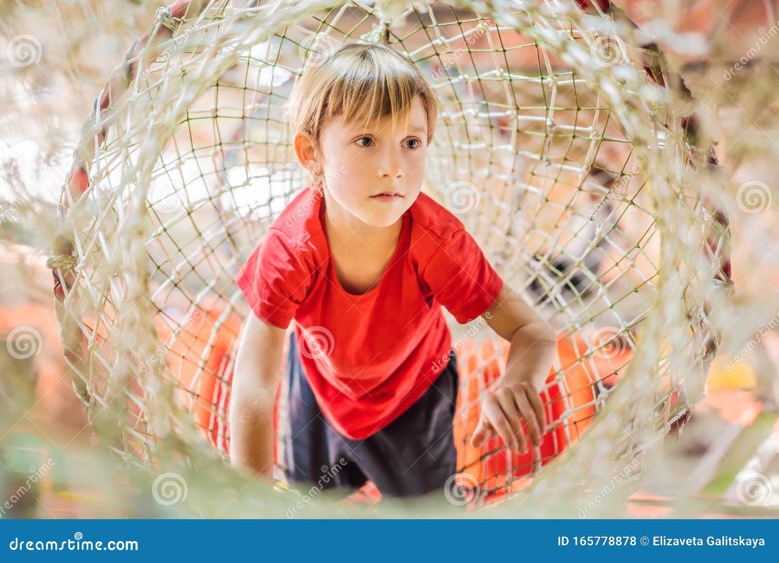 Boy Crawls on a Net in an Obstacle Course Stock Photo - Image of play ...