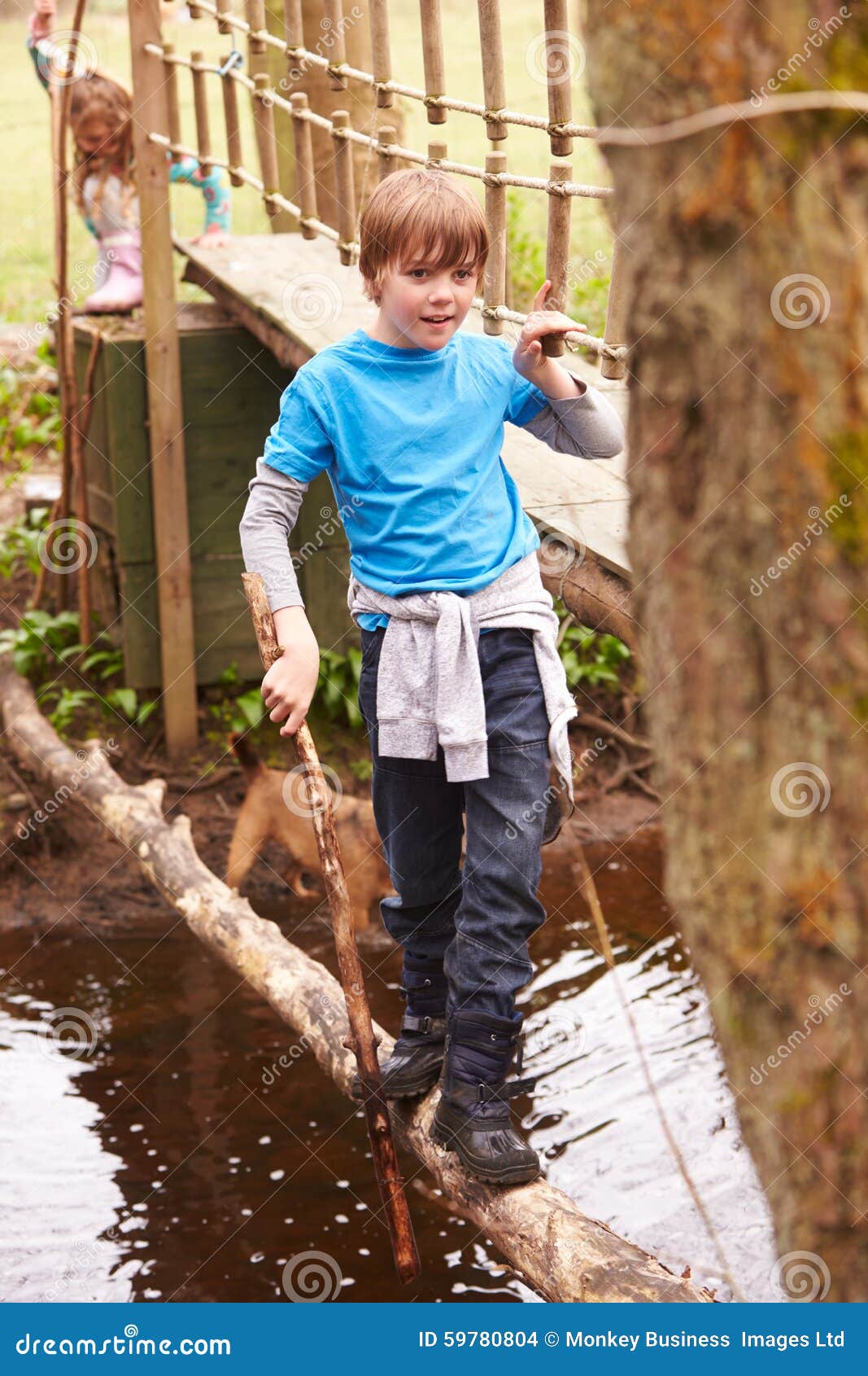Boy Crossing Stream Balancing on Log at Activity Centre Stock Photo ...