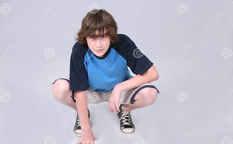 Boy crouching stock image. Image of caucasian, person - 16242799
