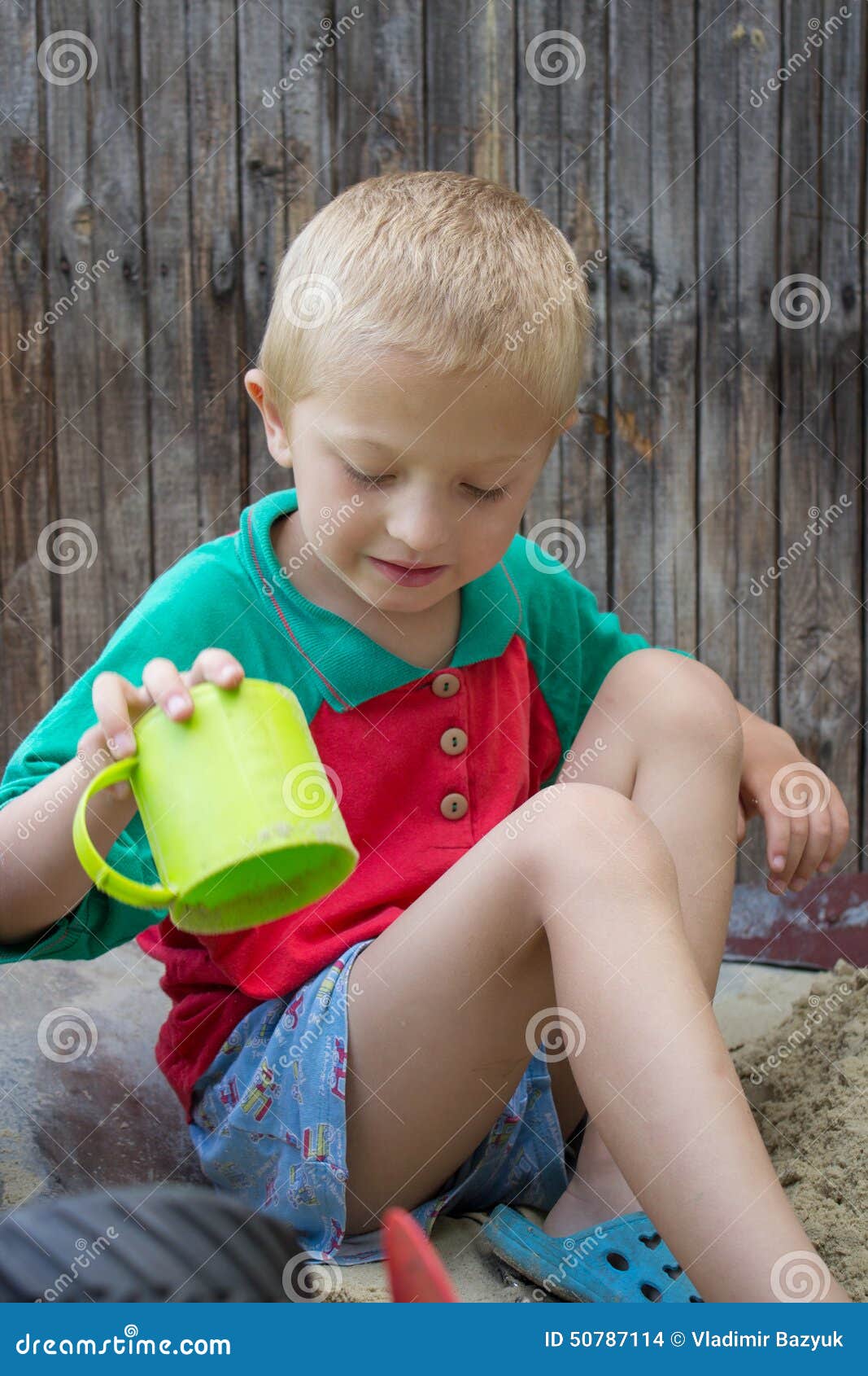 Boy with a cup of sand stock photo. Image of people, face - 50787114