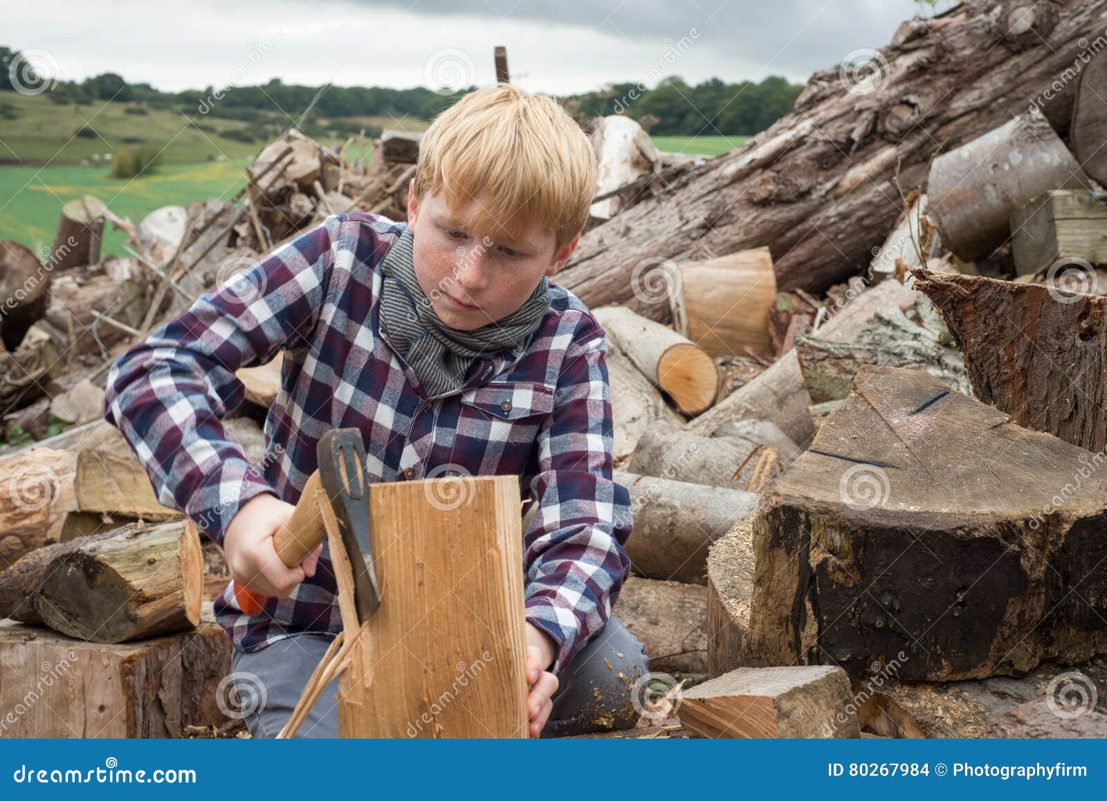 Boy Cutting a Chunk of Firewood with an Axe Stock Photo - Image of ...