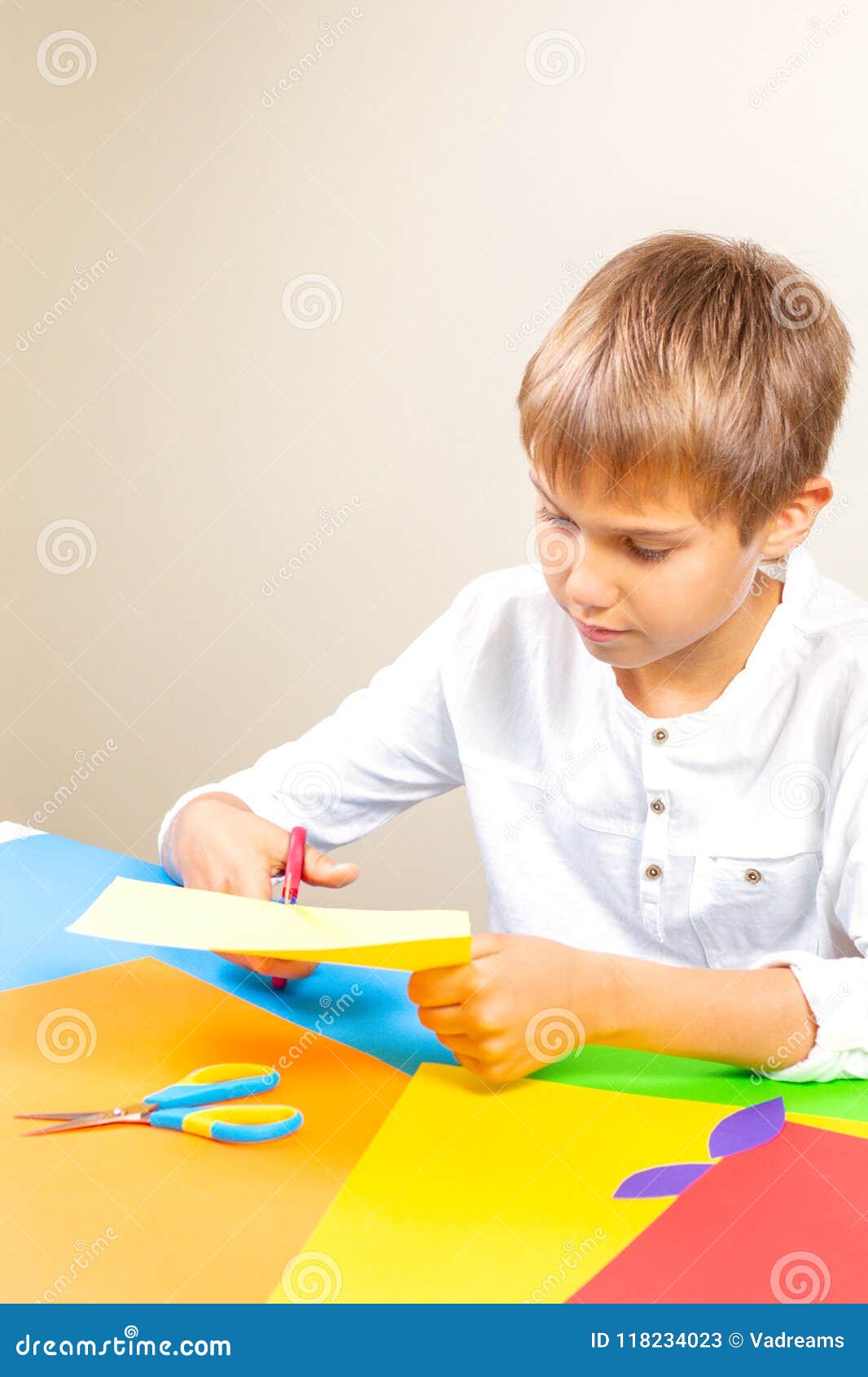 Child Cutting Colored Paper with Scissors at the Table Stock Image ...