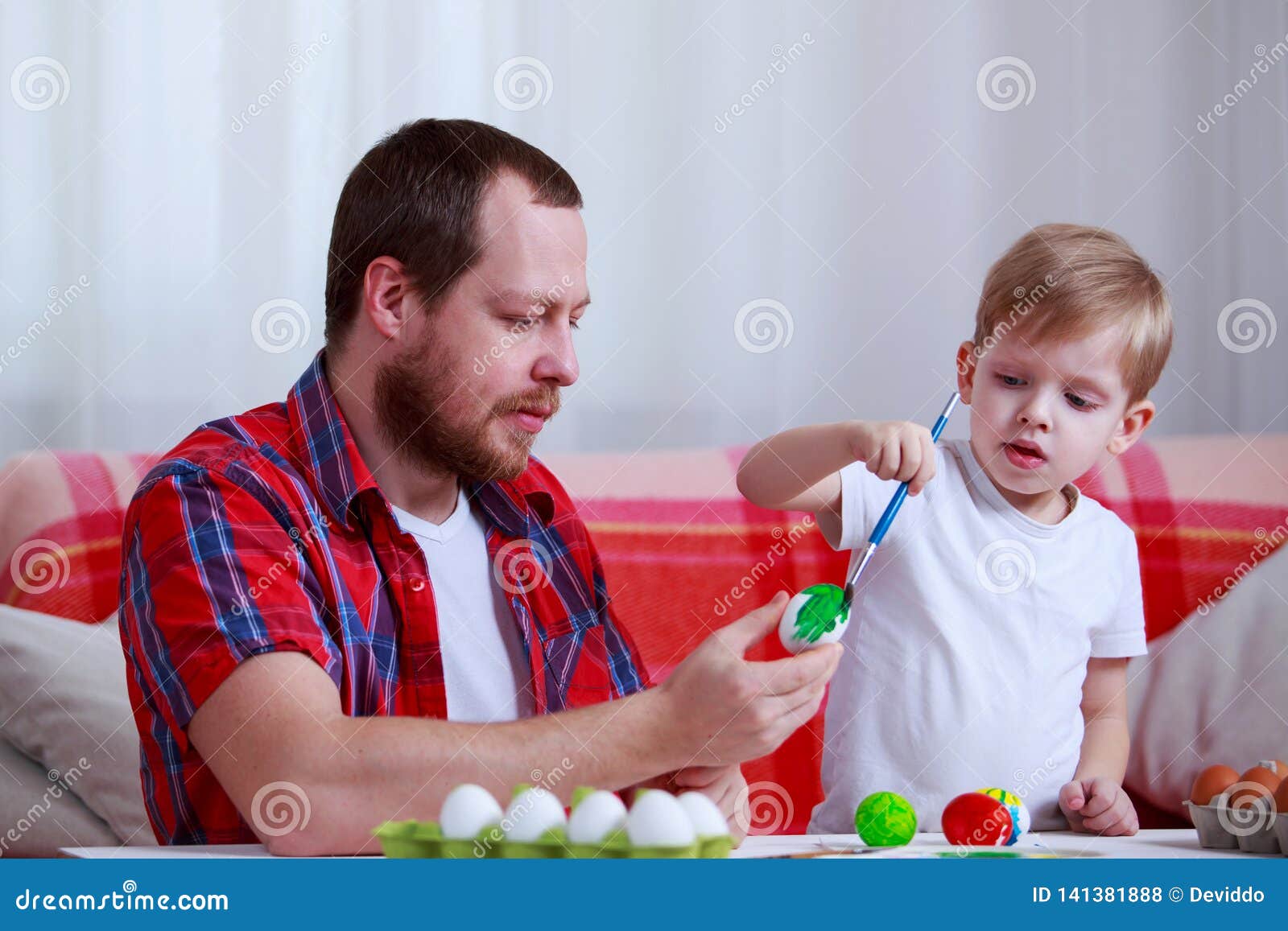 Boy and dad paint eggs stock photo. Image of plaid, child - 141381888