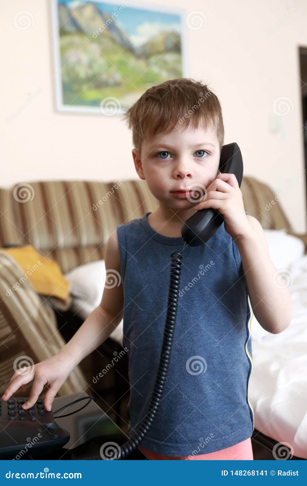 Boy with desk phone stock image. Image of hotel, face - 148268141