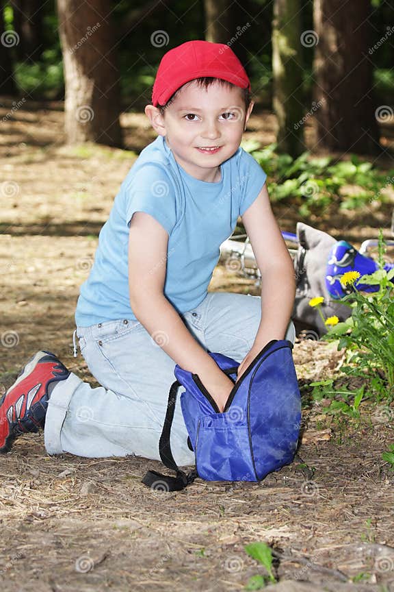 Boy digging in bag stock photo. Image of casual, digging - 14438418