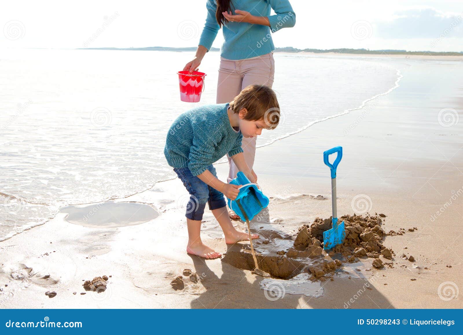 Boy Digging on the Beach stock image. Image of brown - 50298243