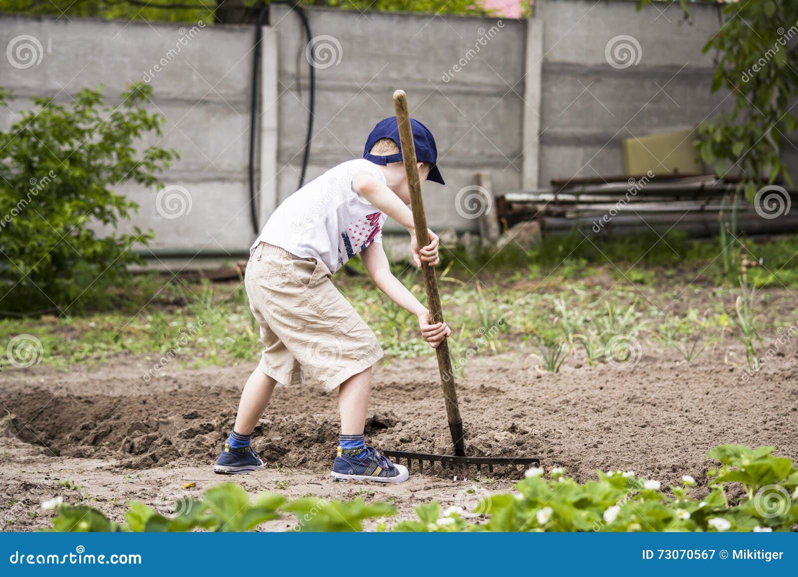 Boy digging a garden stock image. Image of village, education - 73070567