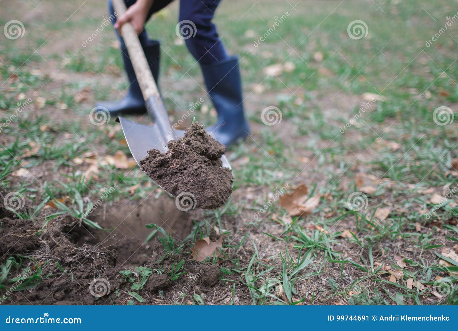 The Boy is Digging the Ground in the Park in the Fall. Worked Process ...
