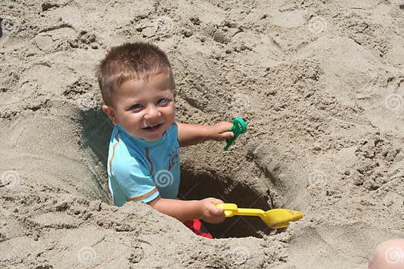 Boy Digging a Hole stock photo. Image of youth, summer - 20074662