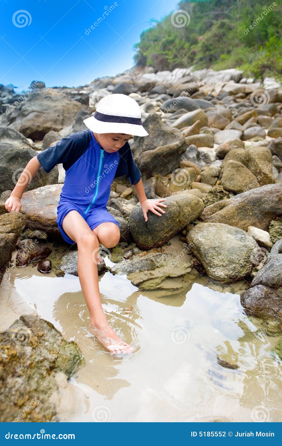 Boy Dipping His Toes in a Rockpool Stock Photo - Image of play ...
