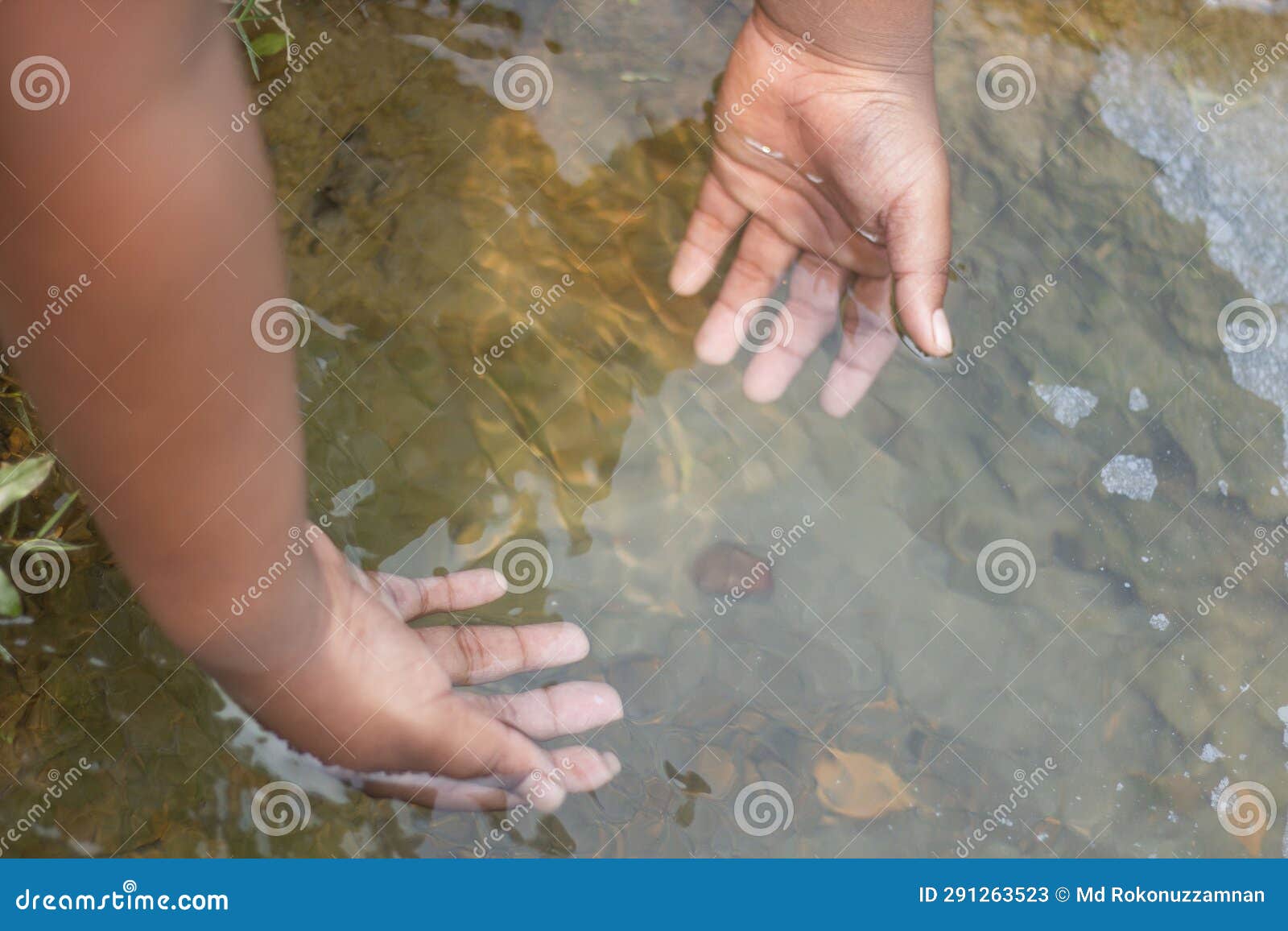 A Boy Dips His Hands in Water Stock Image - Image of people, symbol ...