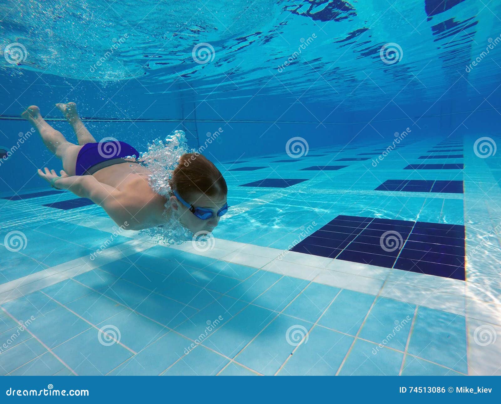 Boy Diving into a Swimming Pool Stock Photo - Image of young, bubbles ...