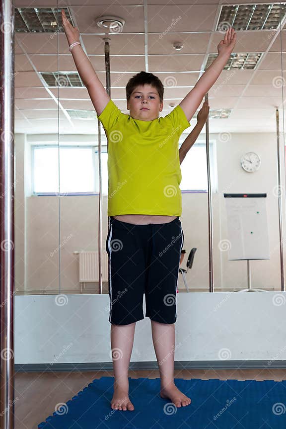 Boy Does Exercise in the Gym Stock Photo - Image of cheerful, fitness ...