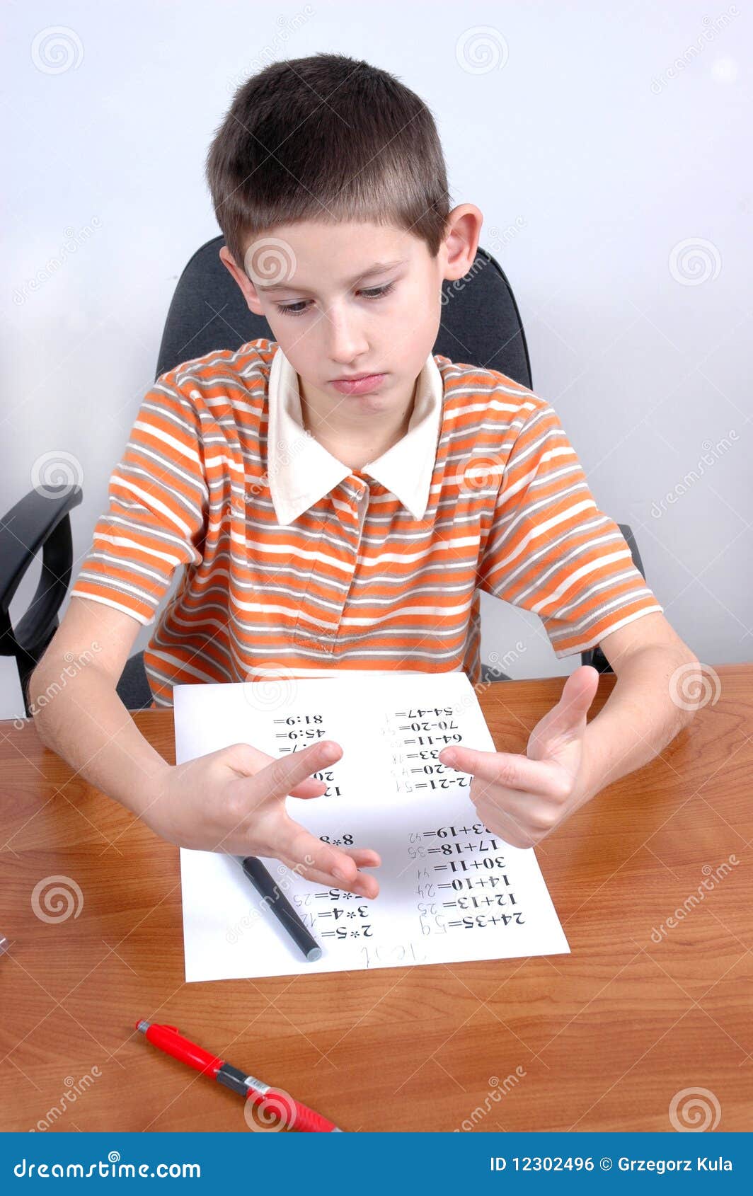 Boy does his math test stock photo. Image of mathematical - 12302496