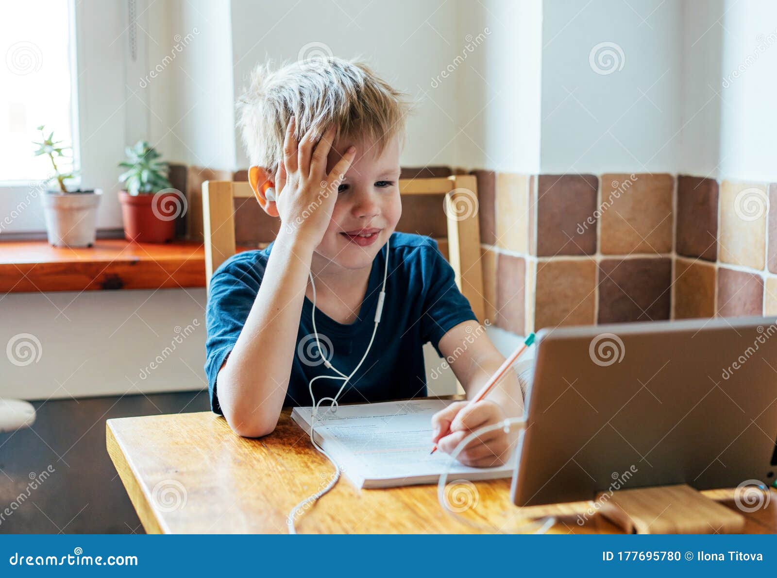 The Boy Does Homework at the Table Stock Photo - Image of digital ...