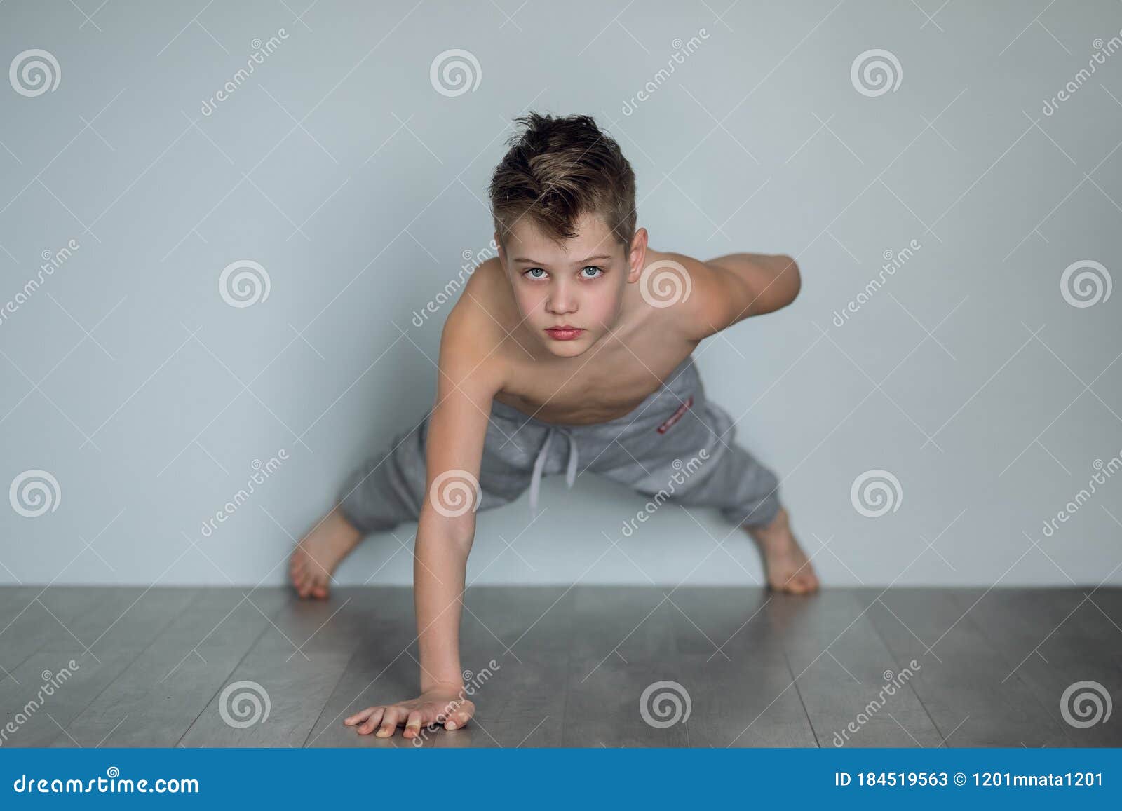 The Boy Does Push-ups from the Floor on One Arm at Home. Quarantine and ...