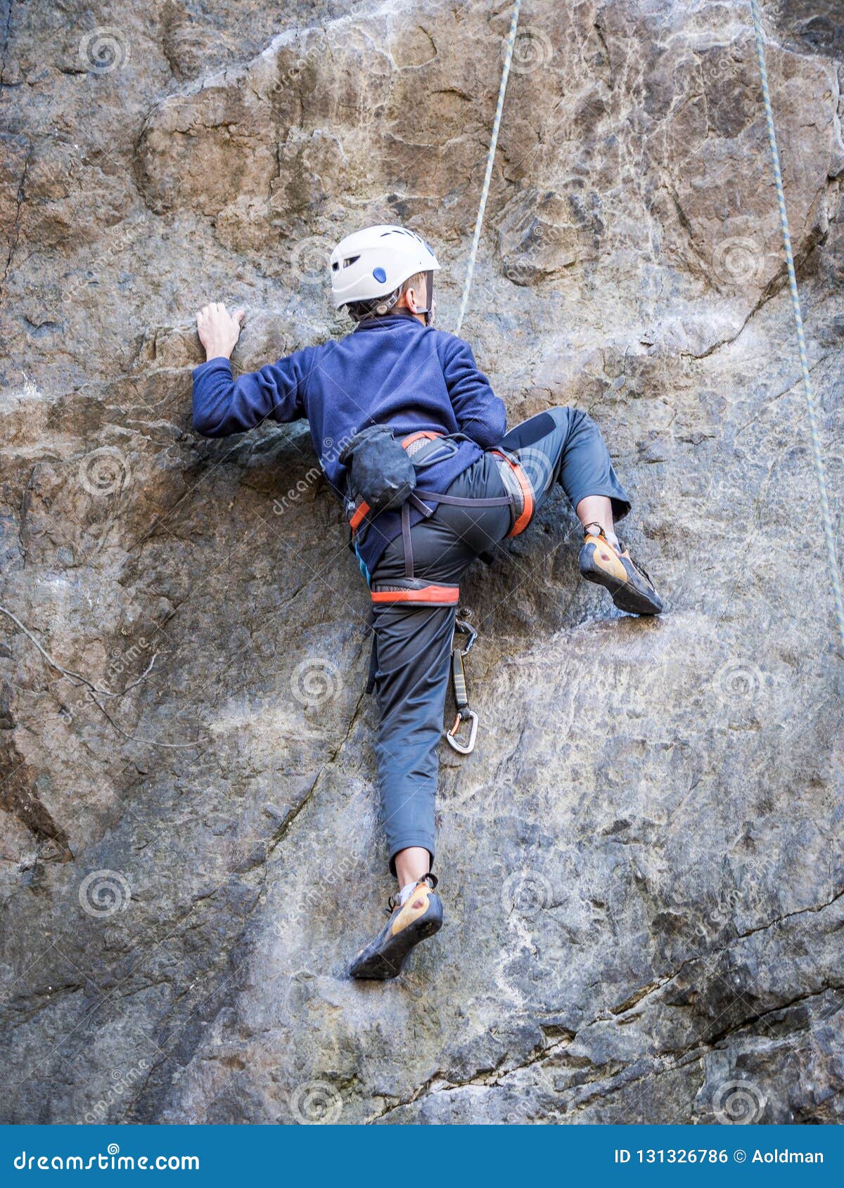 A boy does rock climbing stock photo. Image of alone - 131326786